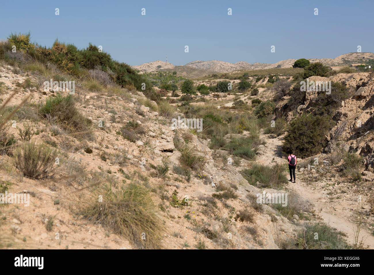 Woman walking in the mountains of Elche, Alicante province in Spain ...