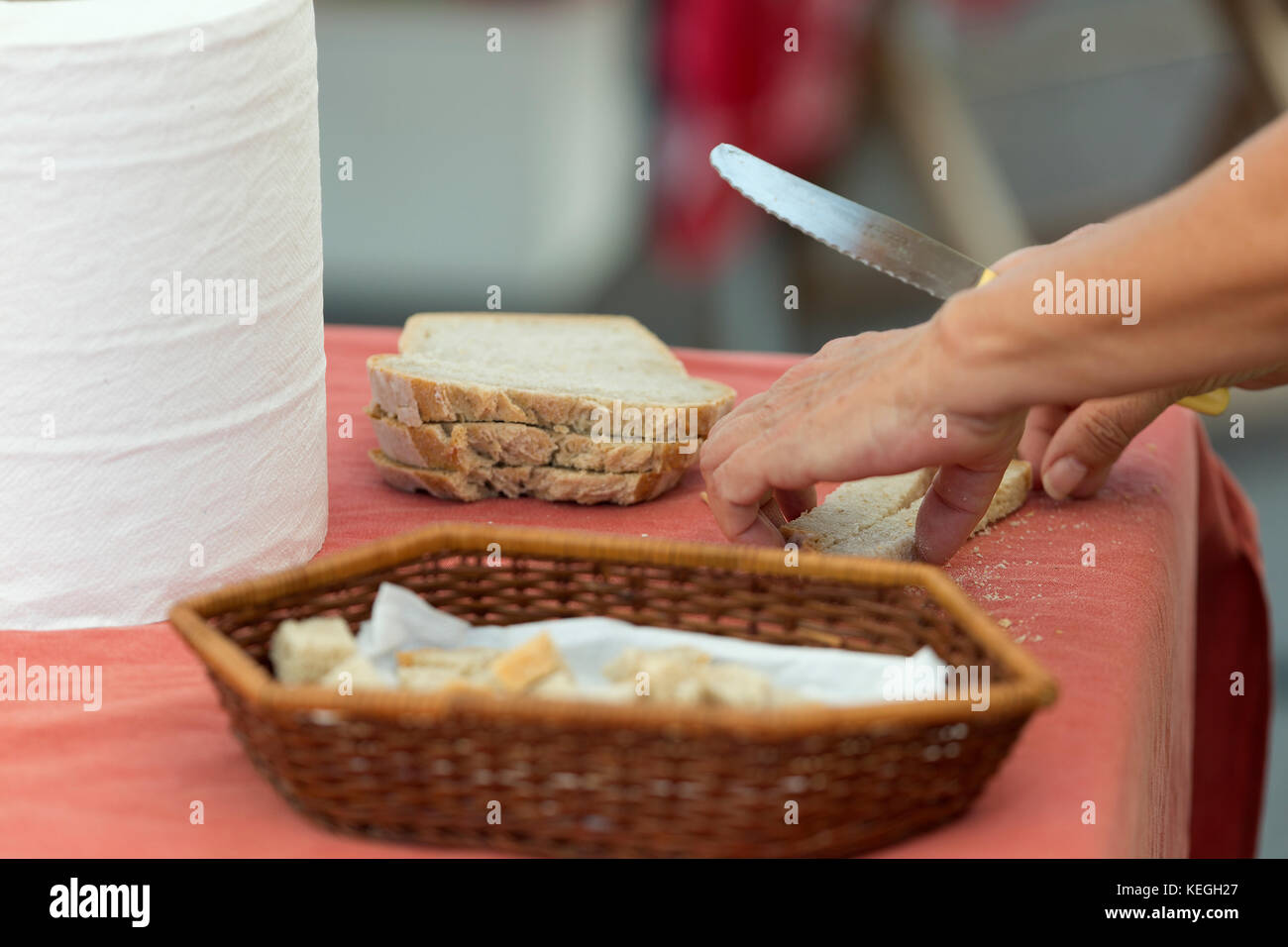 Woman cutting bread in a Spanish market. Horizontal shot Stock Photo ...