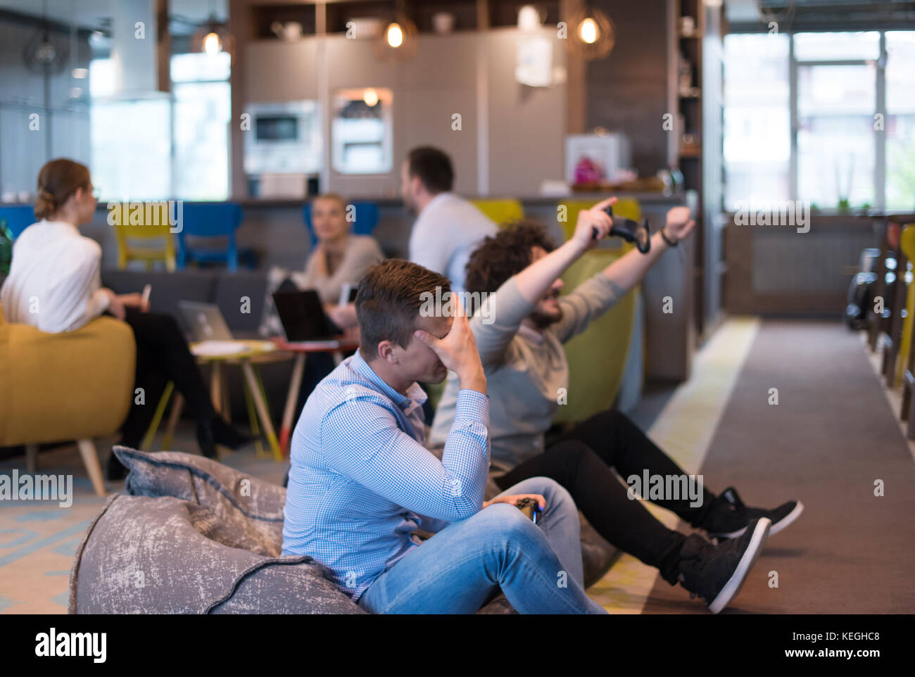 Work hard play hard. Workers Playing computer games in creative startup ...
