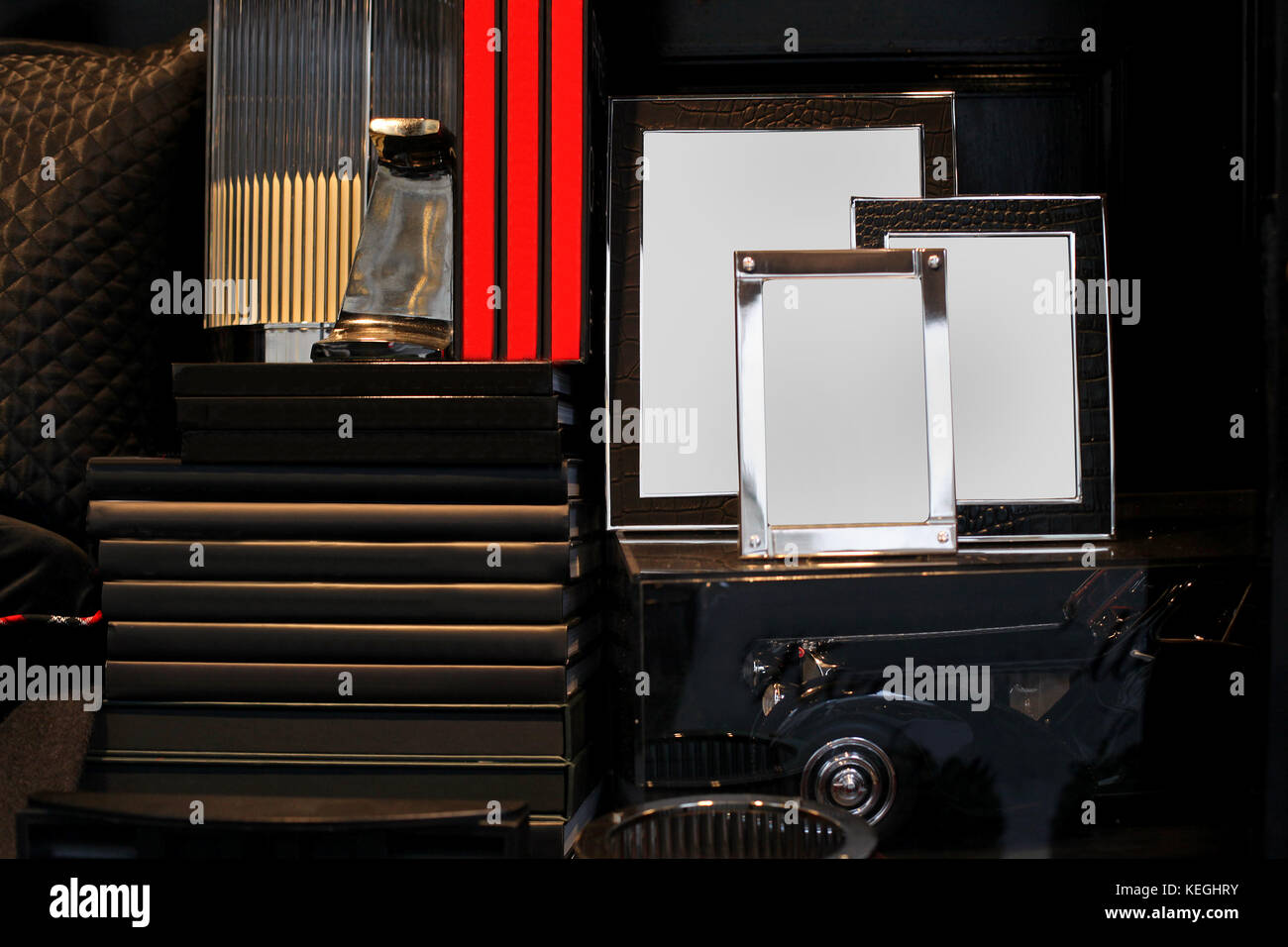 Modern books pile with decorative art frames on shelf Stock Photo - Alamy