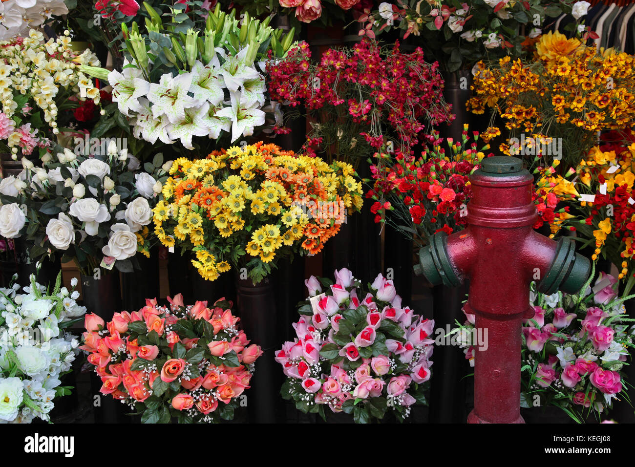 Bunch of attractively arranged flower bouquets next to hydrant Stock ...