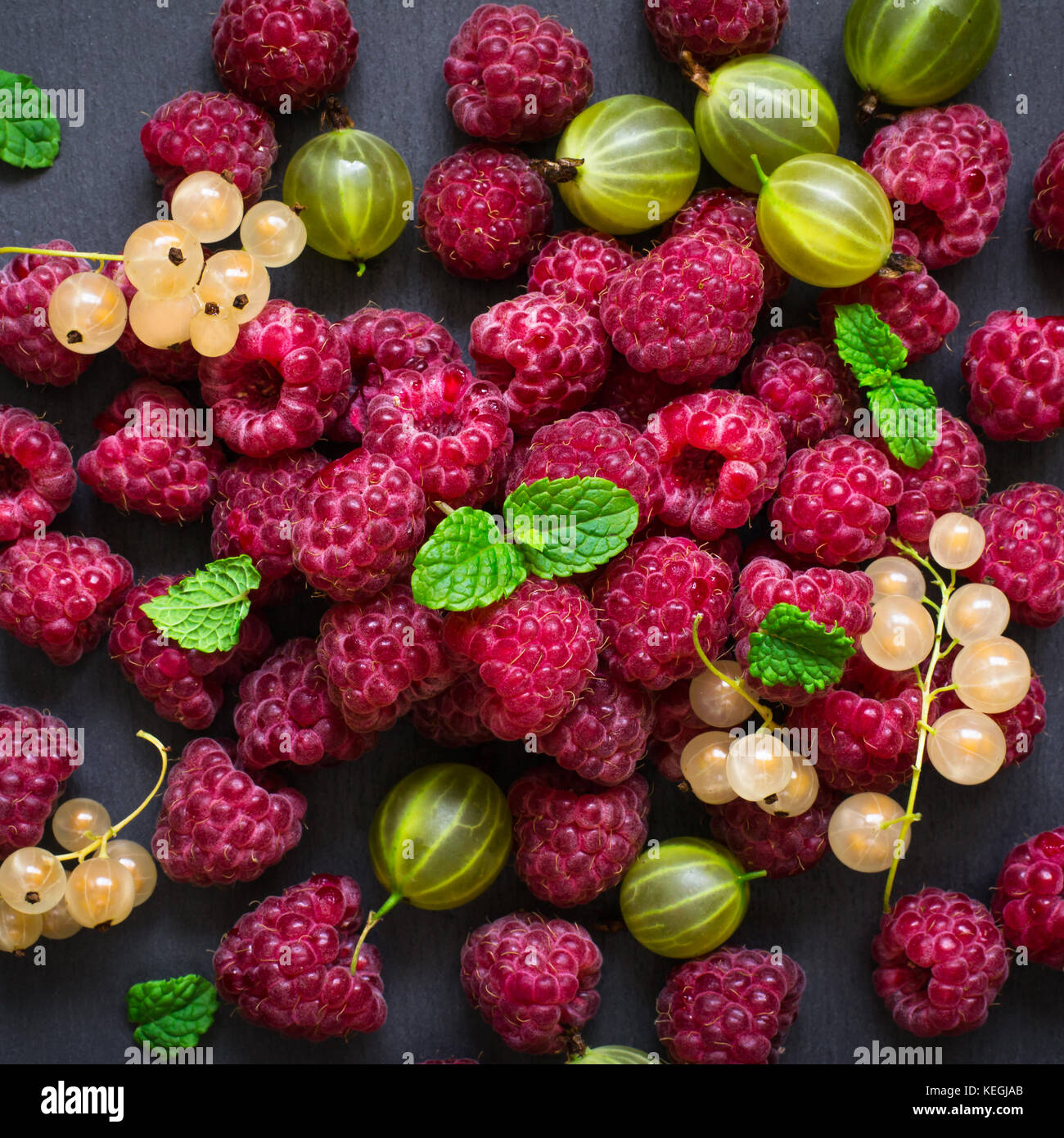 scattering of delicious berries on a black background. Raspberries ...