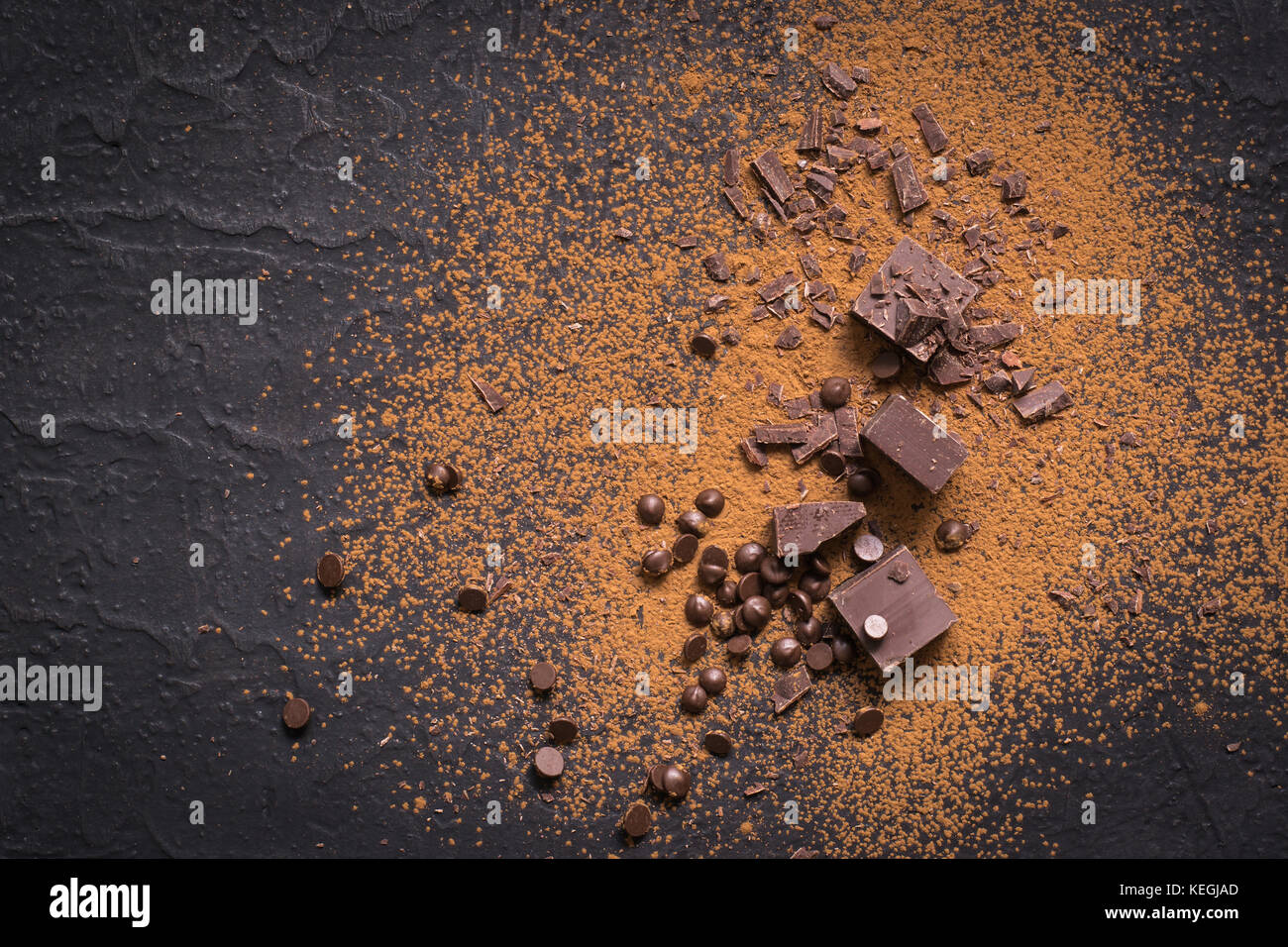 Chocolate background. Pieces and drops of chocolate, cocoa powder on ...