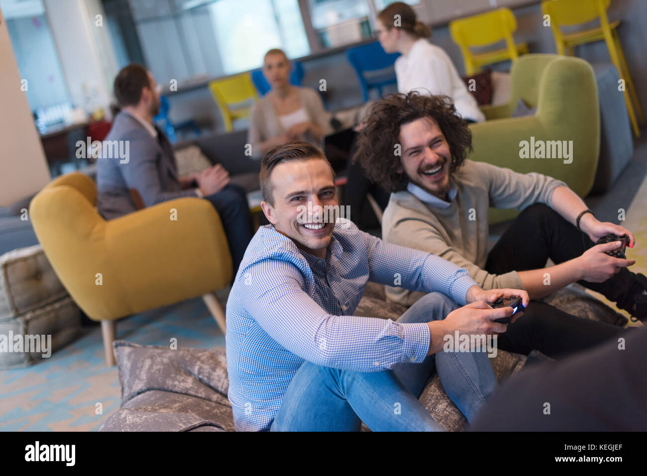 Work hard play hard. Workers Playing computer games in creative startup ...