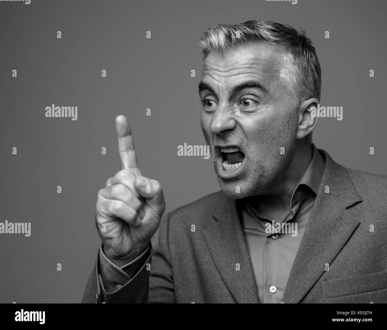 Aggressive angry boss giving a reprimand and arguing, he is pointing ...