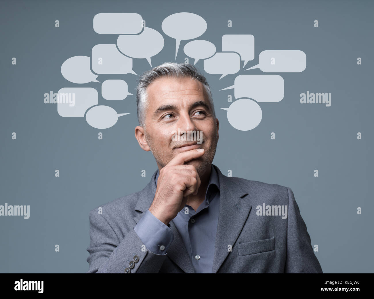 Creative smart business with speech bubbles around his head ...