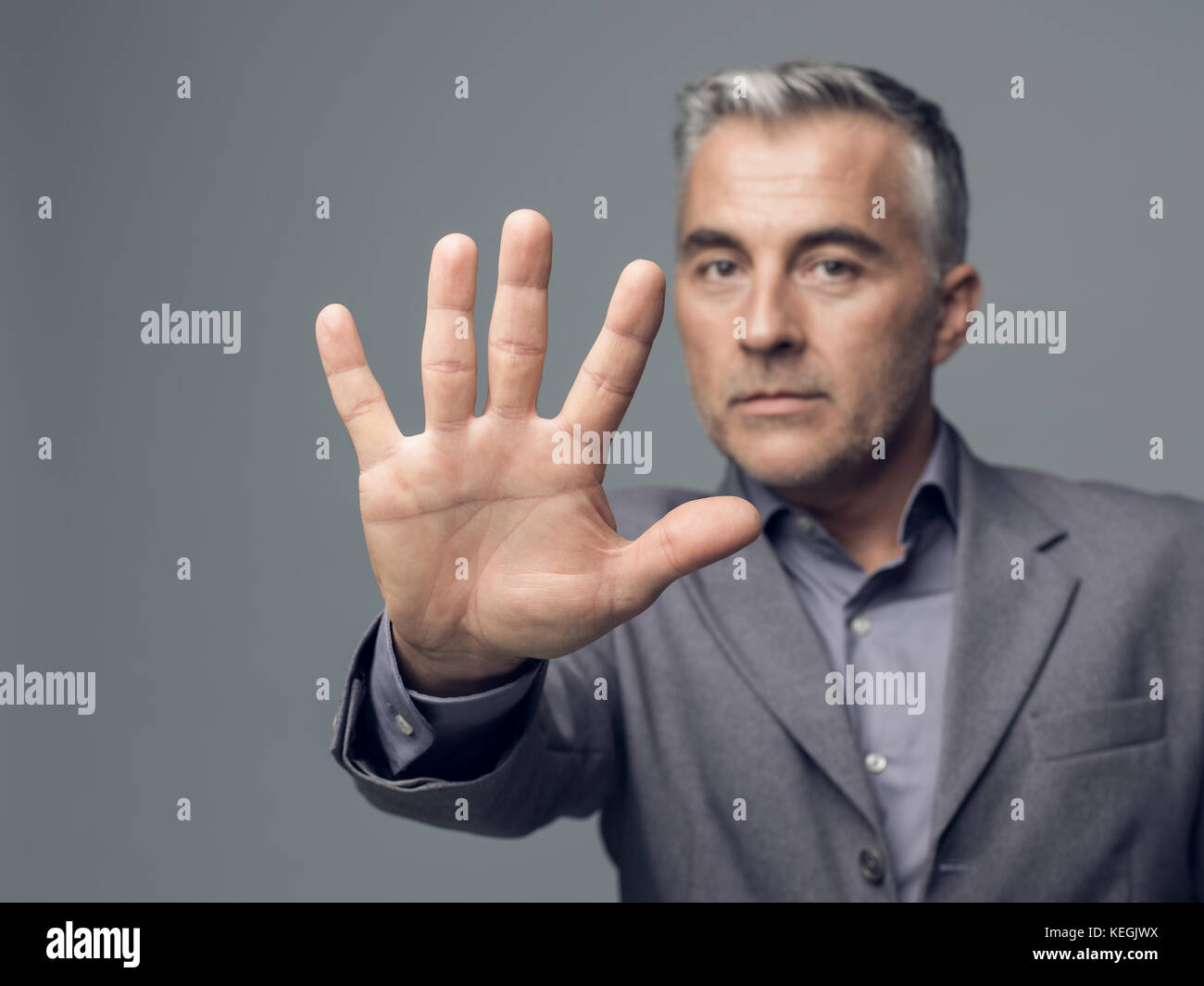 Businessman doing a stop gesture with his hand, rejection and denial ...