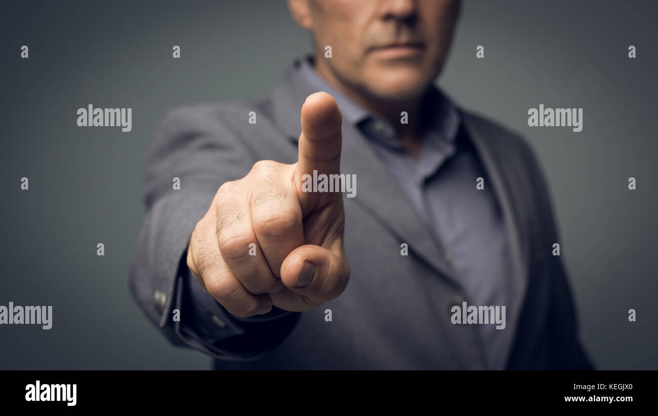 Businessman pointing at camera with his index finger Stock Photo - Alamy
