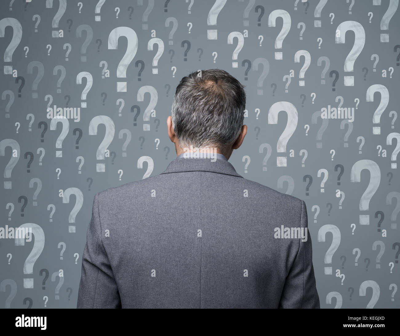 Businessman surrounded by question marks: business decisions, problem ...