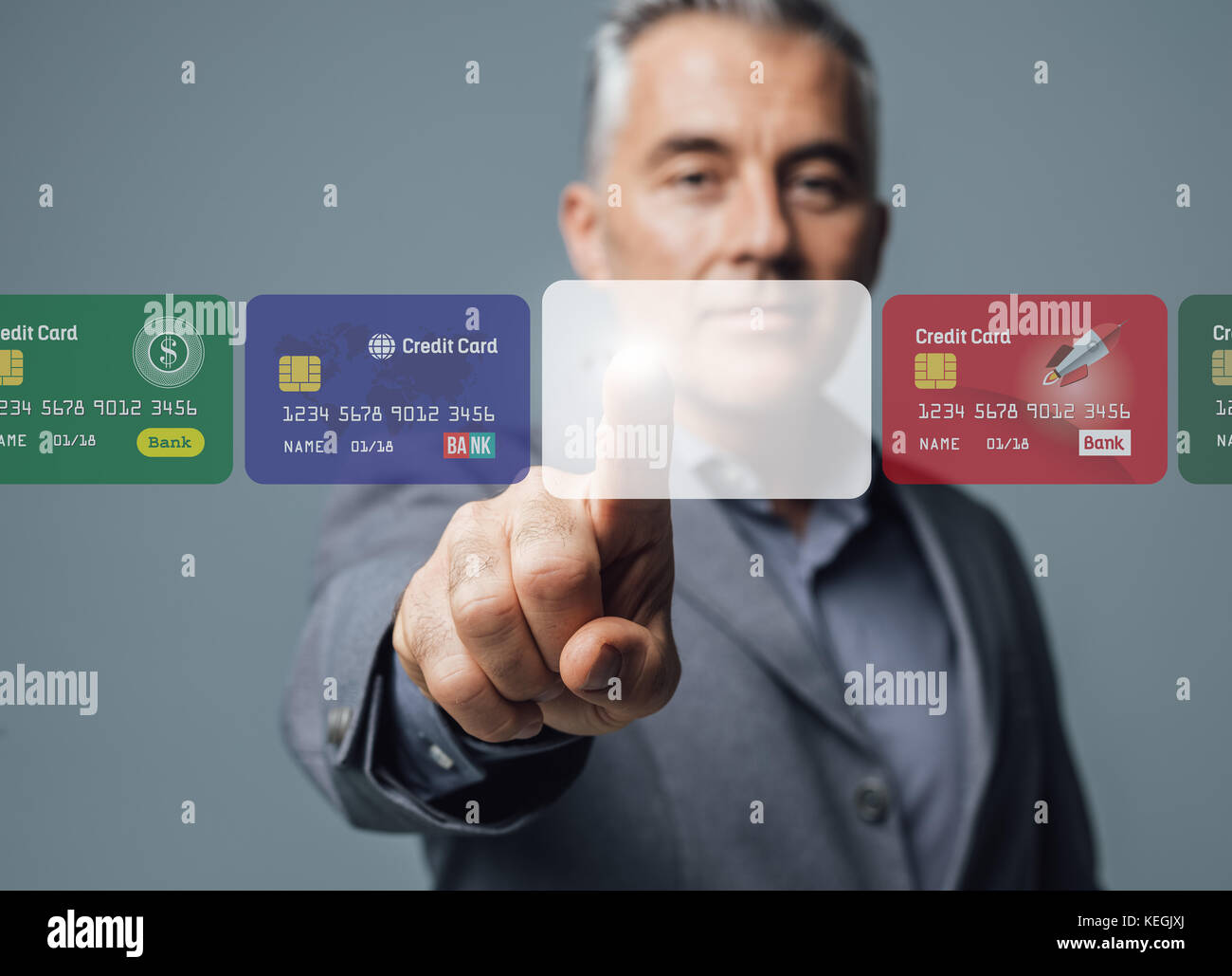Businessman selecting a credit card on a visual interactive interface ...