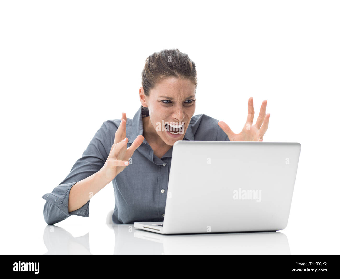 Angry female office worker yelling at the laptop screen, stress and ...