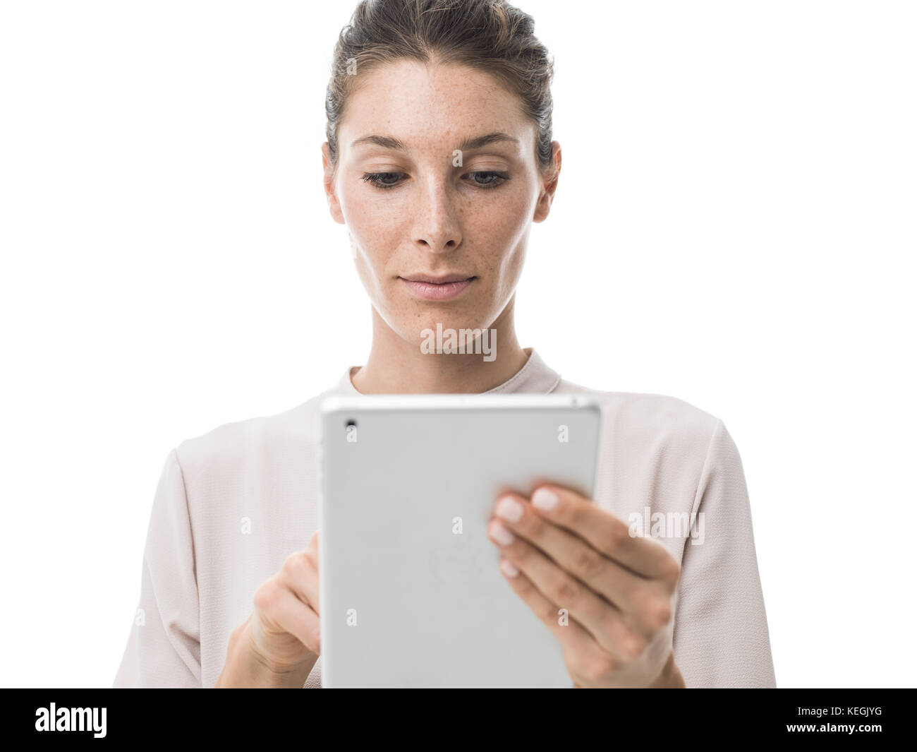 Young attractive woman connecting with a digital touch screen tablet ...