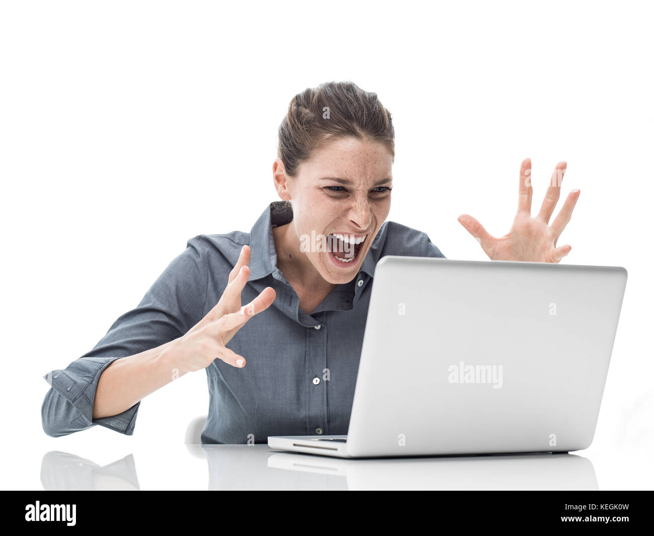 Angry female office worker yelling at the laptop screen, stress and ...