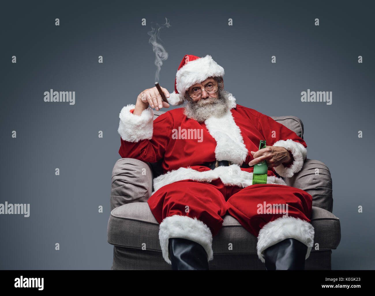 Bad Santa celebrating Christmas at home alone, he is smoking a cigar ...