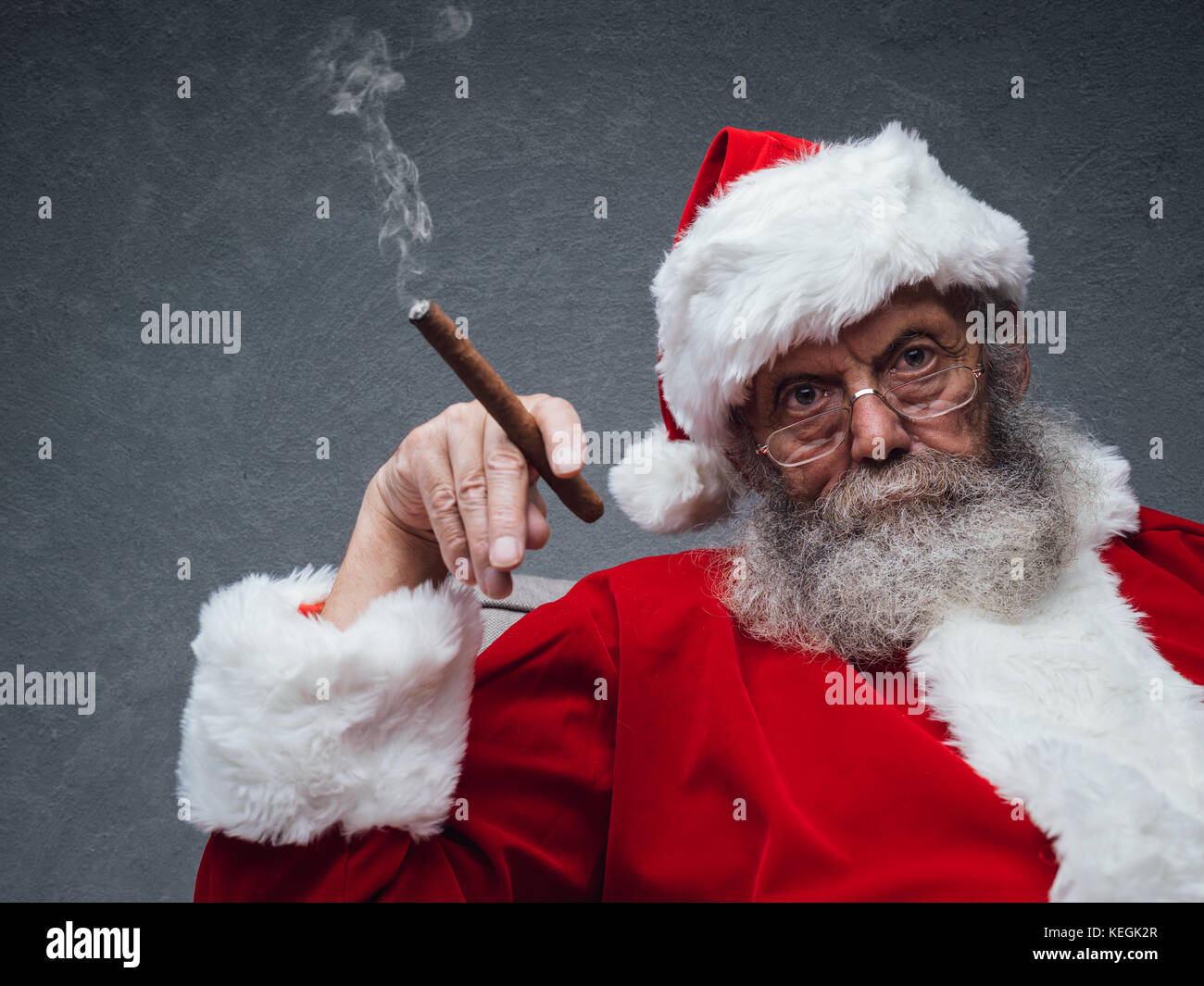 Bad Santa smoking a cigar and celebrating Christmas, he is staring at ...
