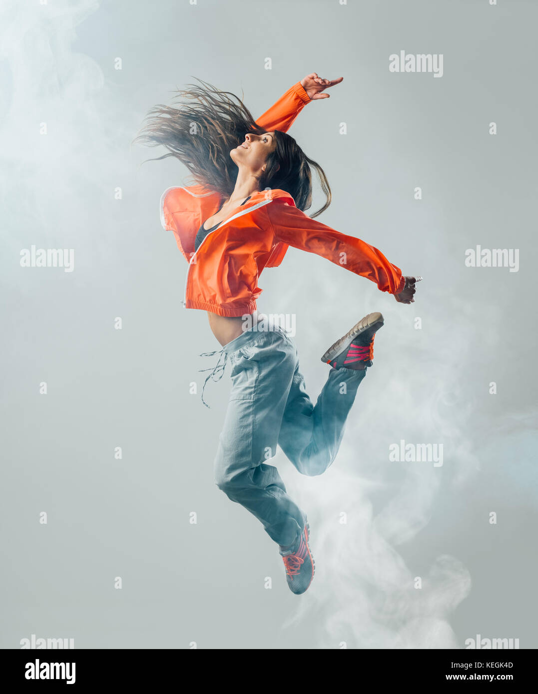 Dynamic modern style performer jumping and dancing: vitality, happiness ...