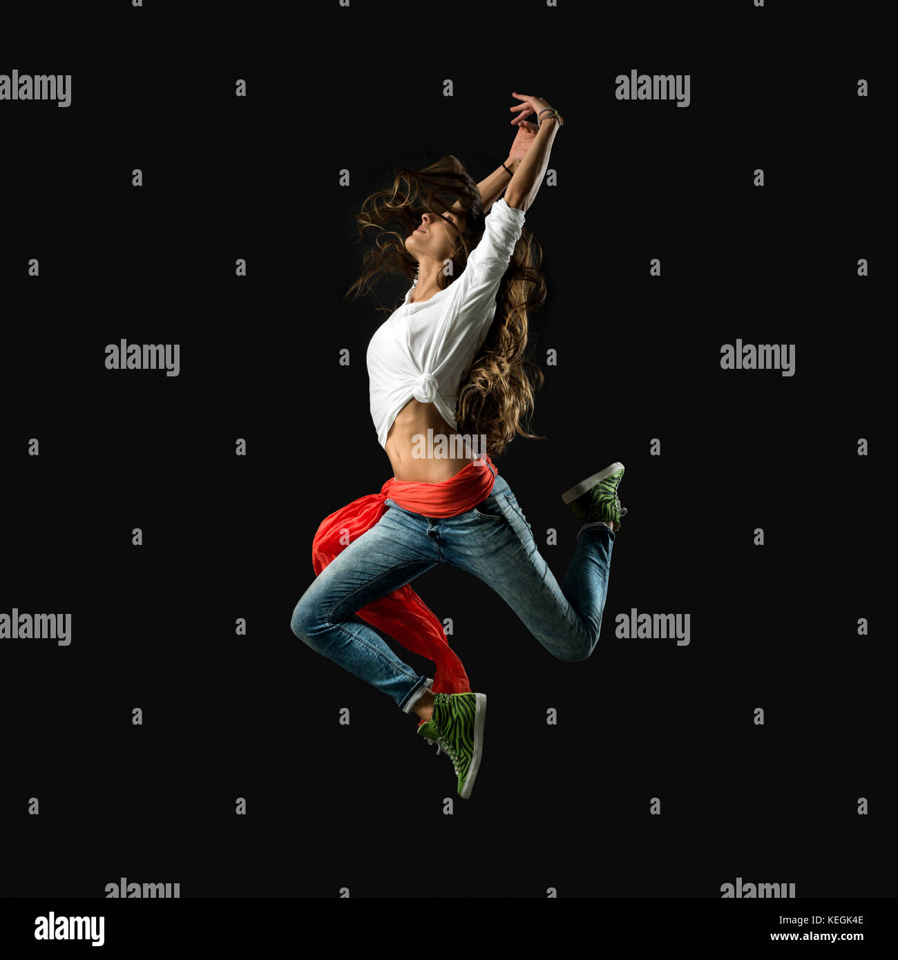 Female modern style performer dancing on dark background, she is ...
