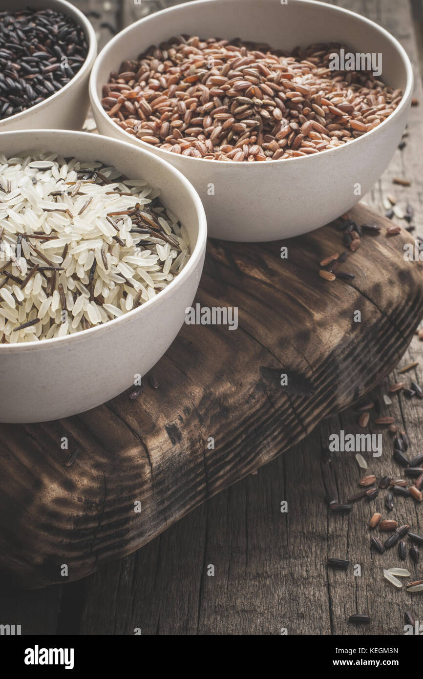 collection of different varieties of rice on wooden rustic background ...