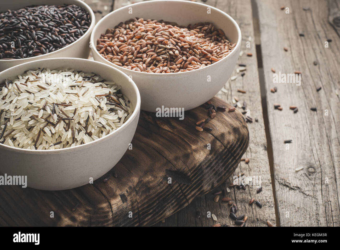 collection of different varieties of rice on wooden rustic background ...