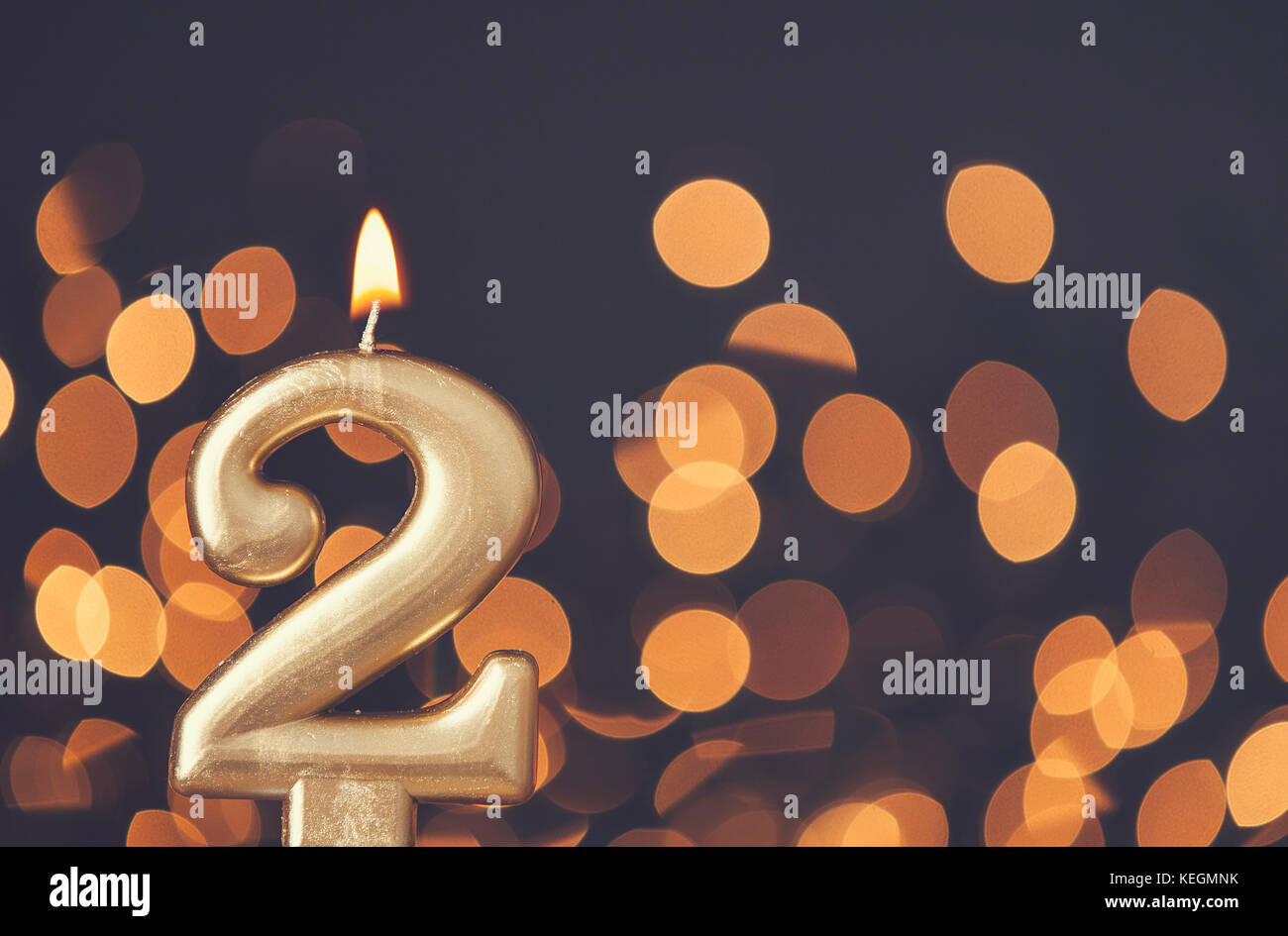 Gold number 2 celebration candle against blurred light background Stock ...