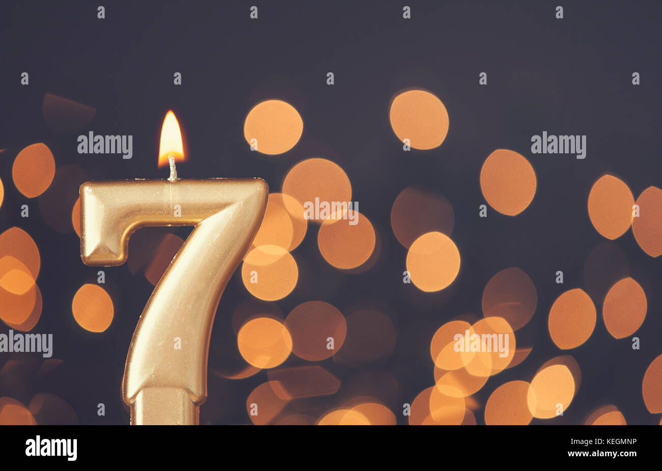Gold number 7 celebration candle against blurred light background Stock ...