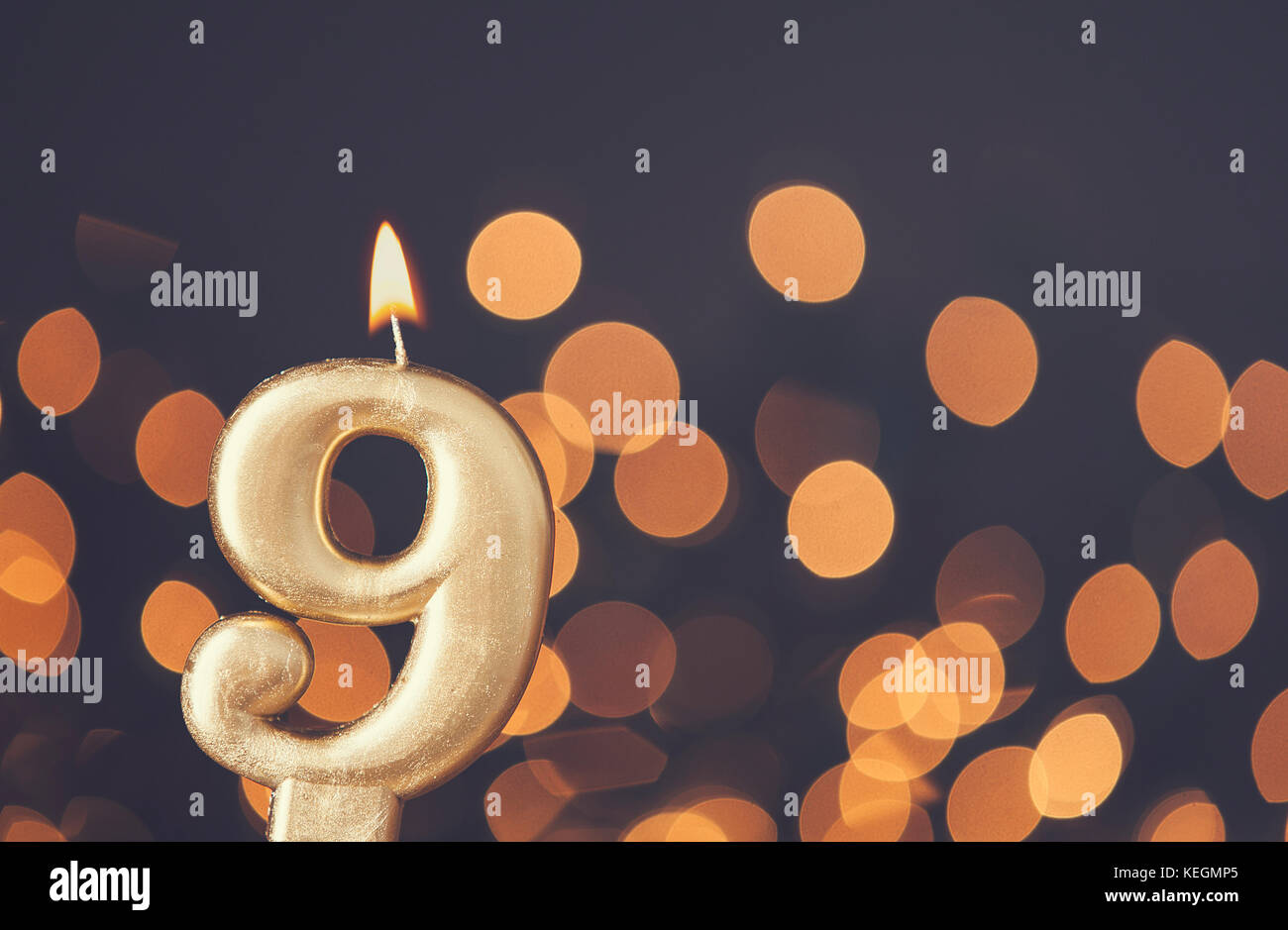 Gold number 9 celebration candle against blurred light background Stock ...