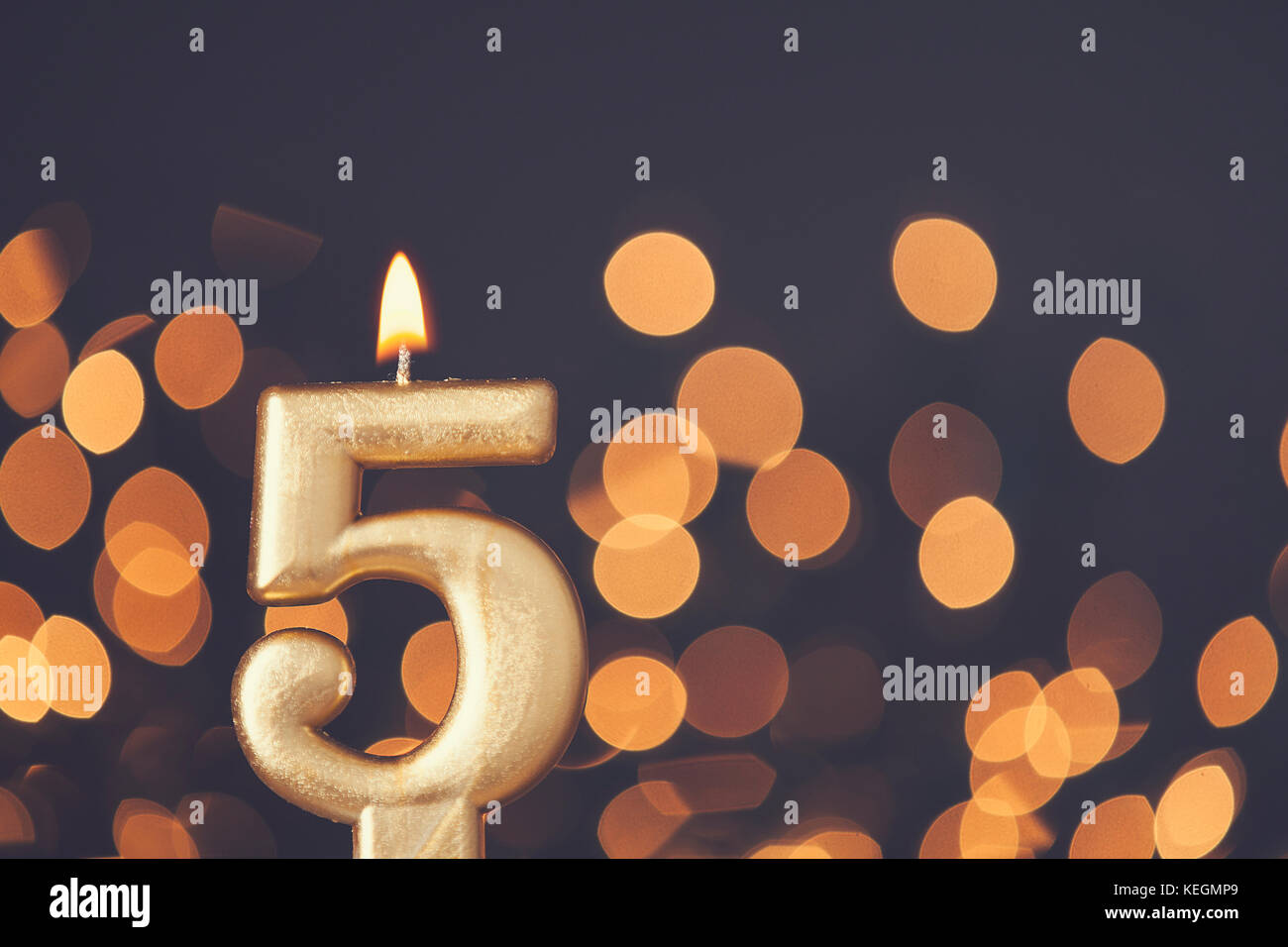 Gold number 5 celebration candle against blurred light background Stock ...