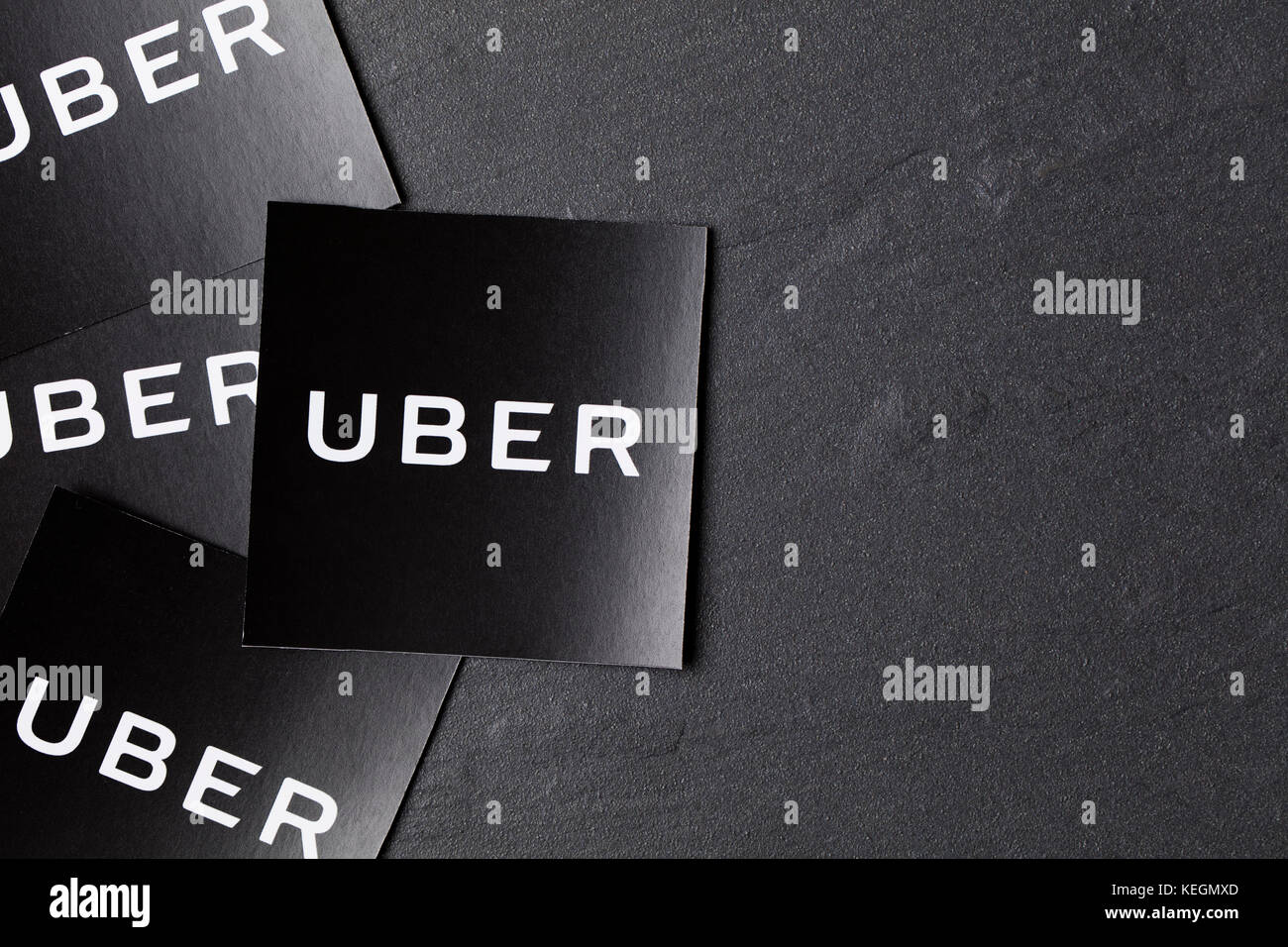 A photograph of the Uber logo. Uber is a popular taxi style transport ...
