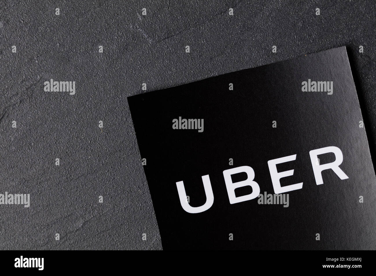 A photograph of the Uber logo. Uber is a popular taxi style transport ...