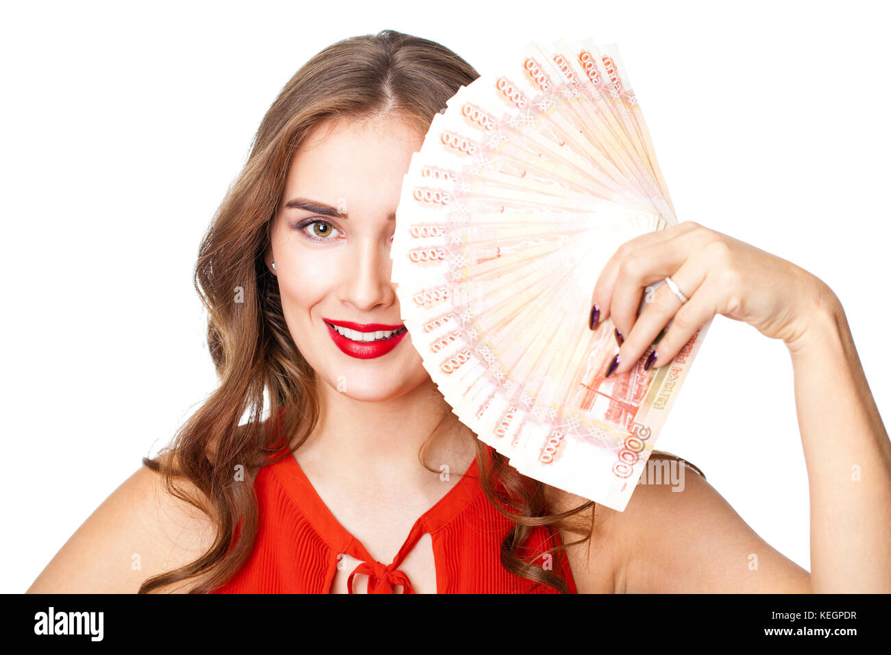 Russian rubles. Young happy woman holding a fan of money, isolated over ...