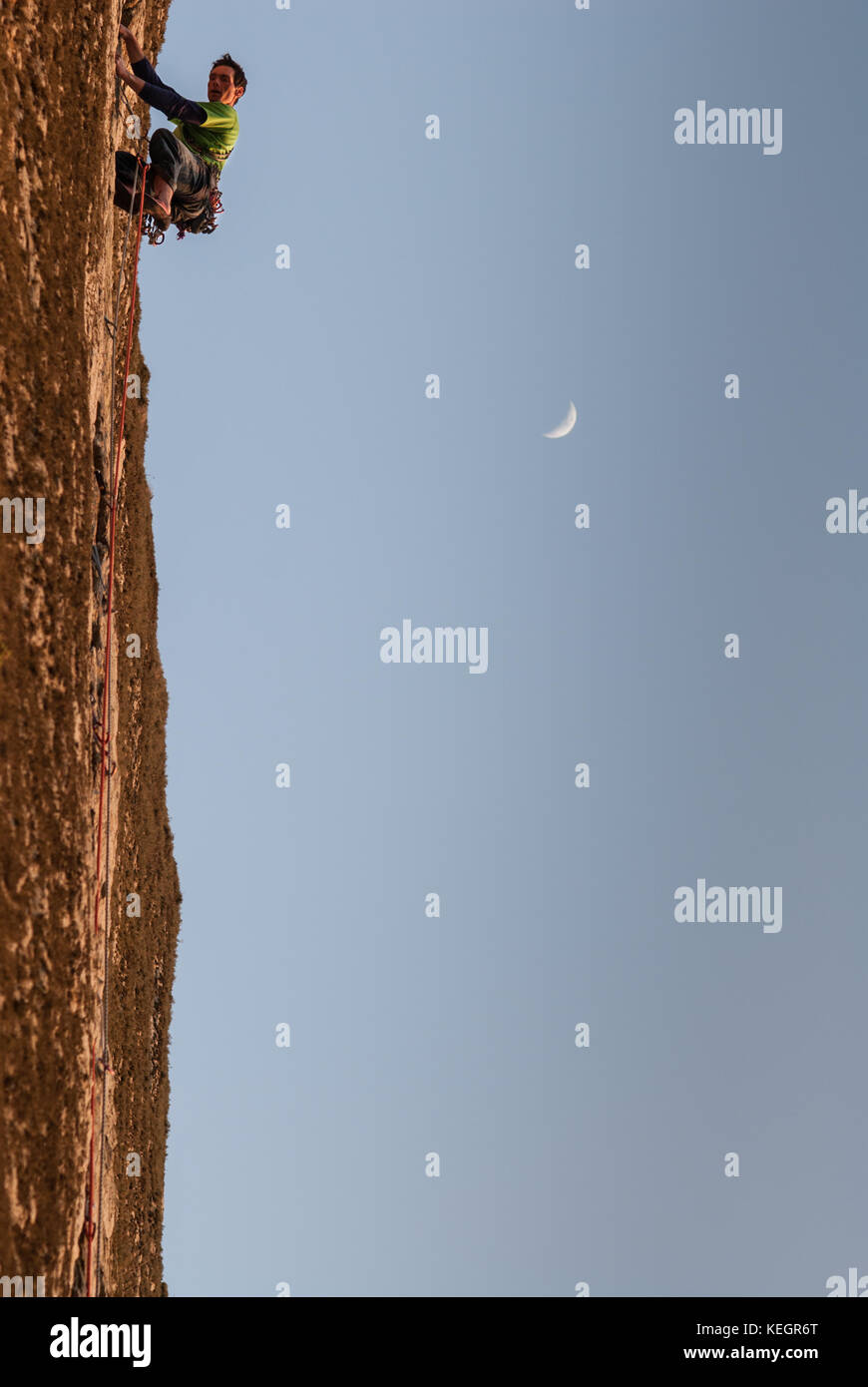 climber and moon, rock climber on sea cliff north Wales, male ...
