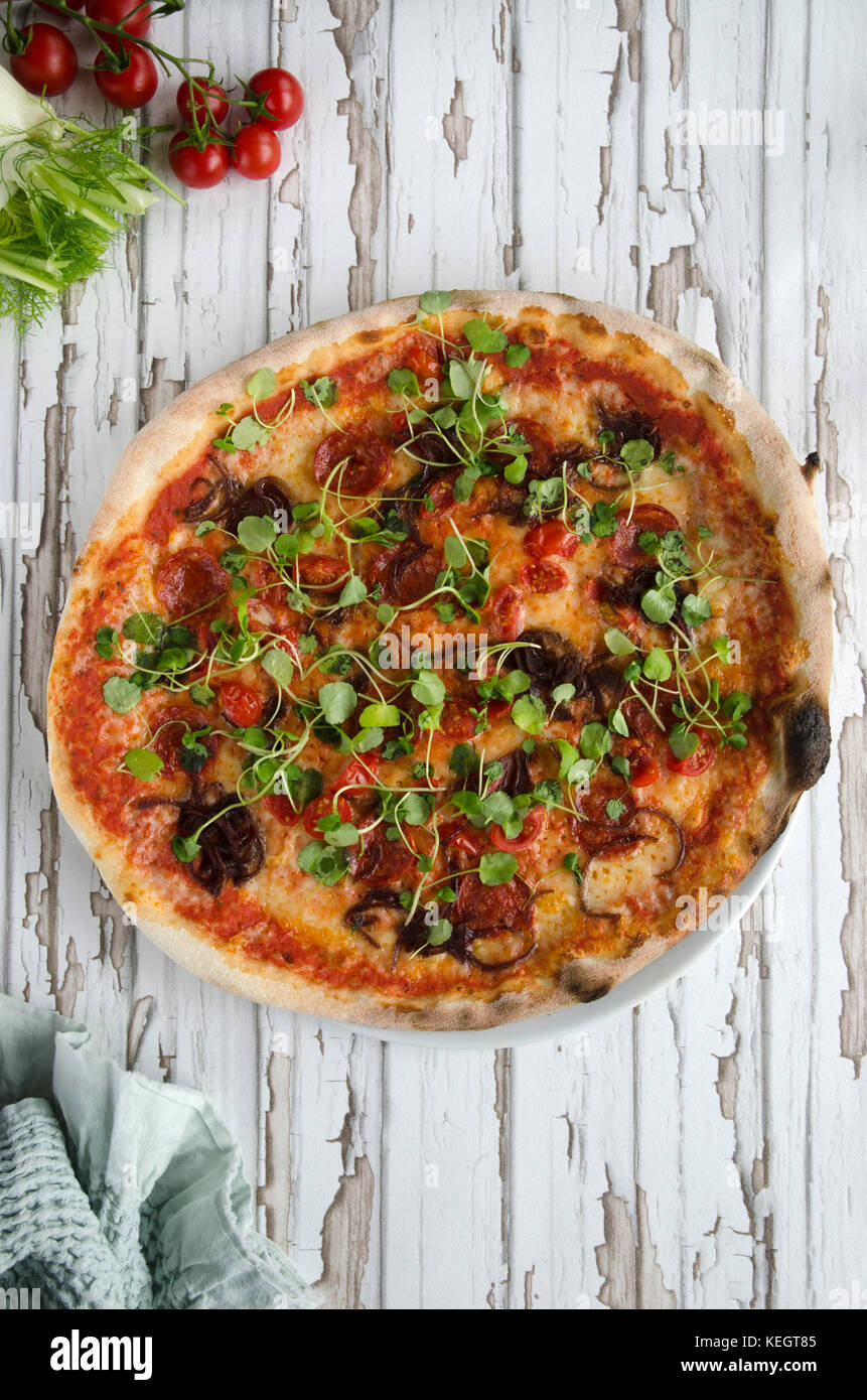 Pepperoni pizza topped with fresh cress Stock Photo - Alamy