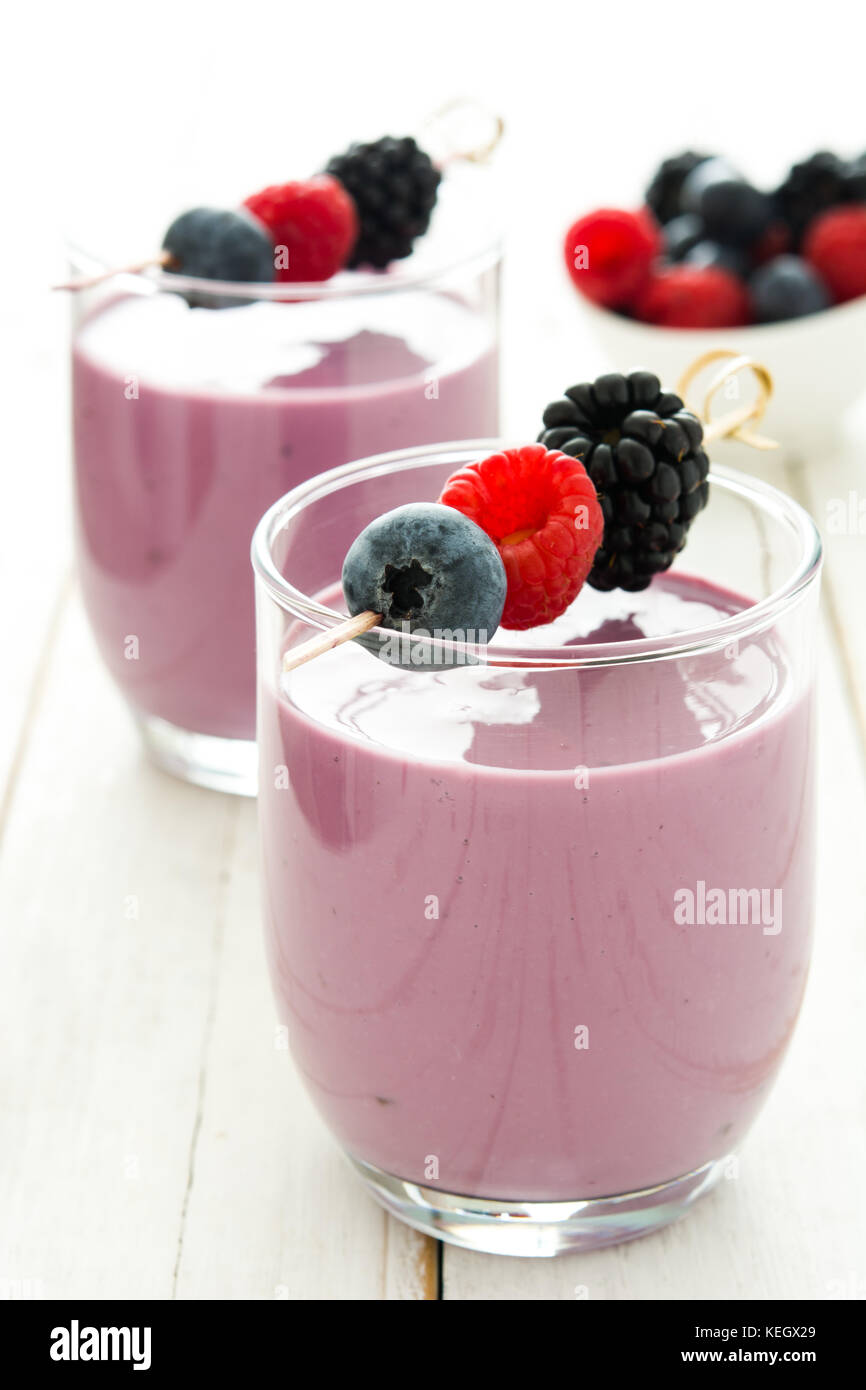 Healthy berry smoothie in glass on white wooden table Stock Photo - Alamy