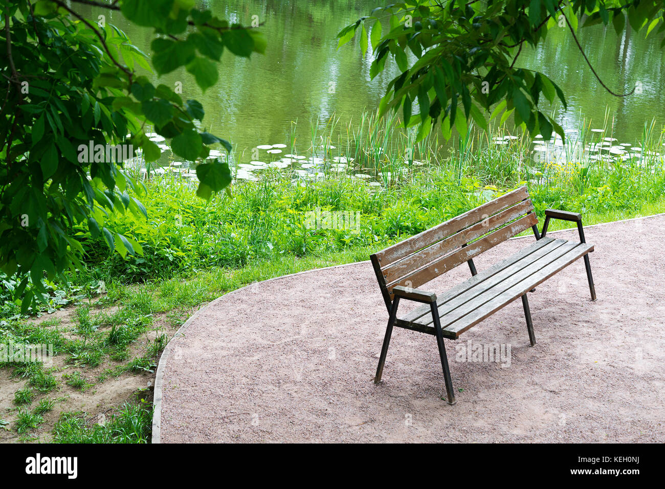 Bench at the track and the river in the Park Stock Photo - Alamy