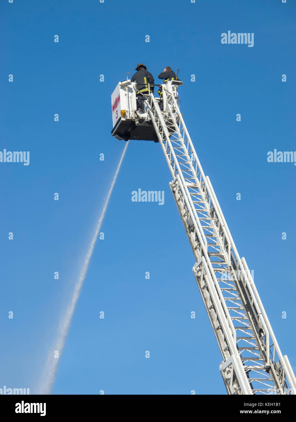 Fire Fighters hosing down a blaze Stock Photo - Alamy