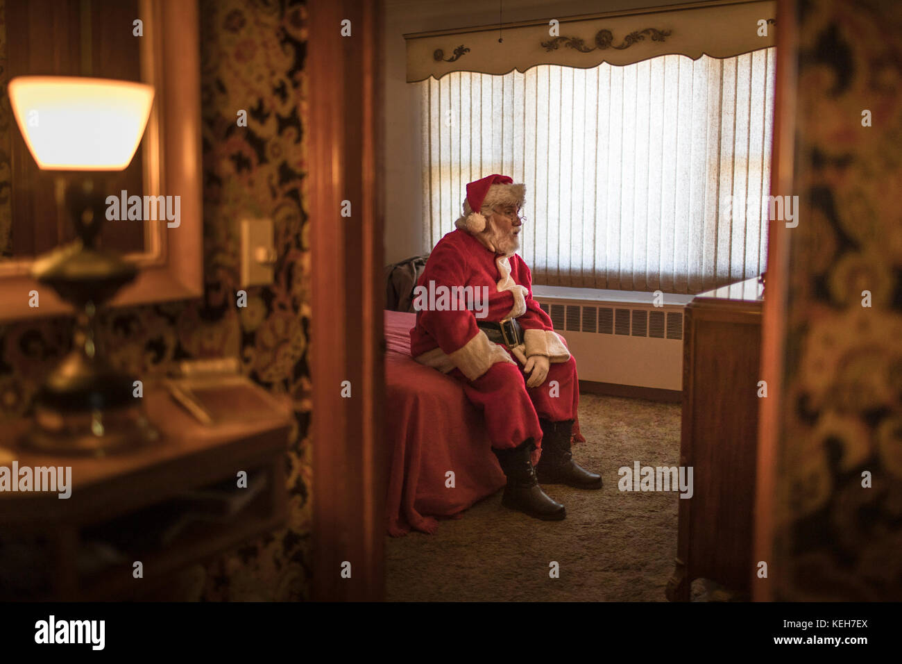 Caucasian Santa sitting on bed Stock Photo - Alamy