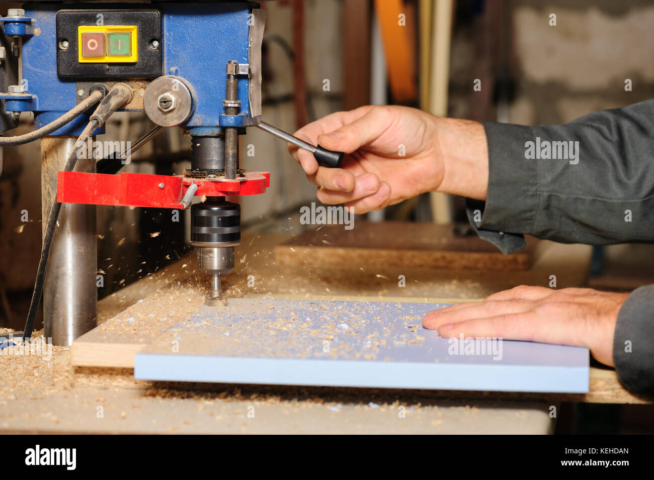 worker hands using wood milling cutter machine on laminated chipboard ...