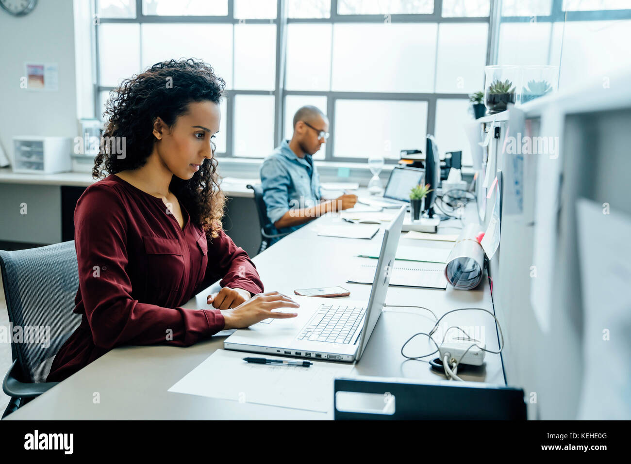 Businesswoman using laptop in office Stock Photo - Alamy