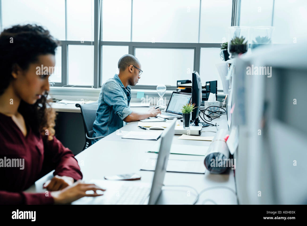 Business people using laptops in office Stock Photo - Alamy