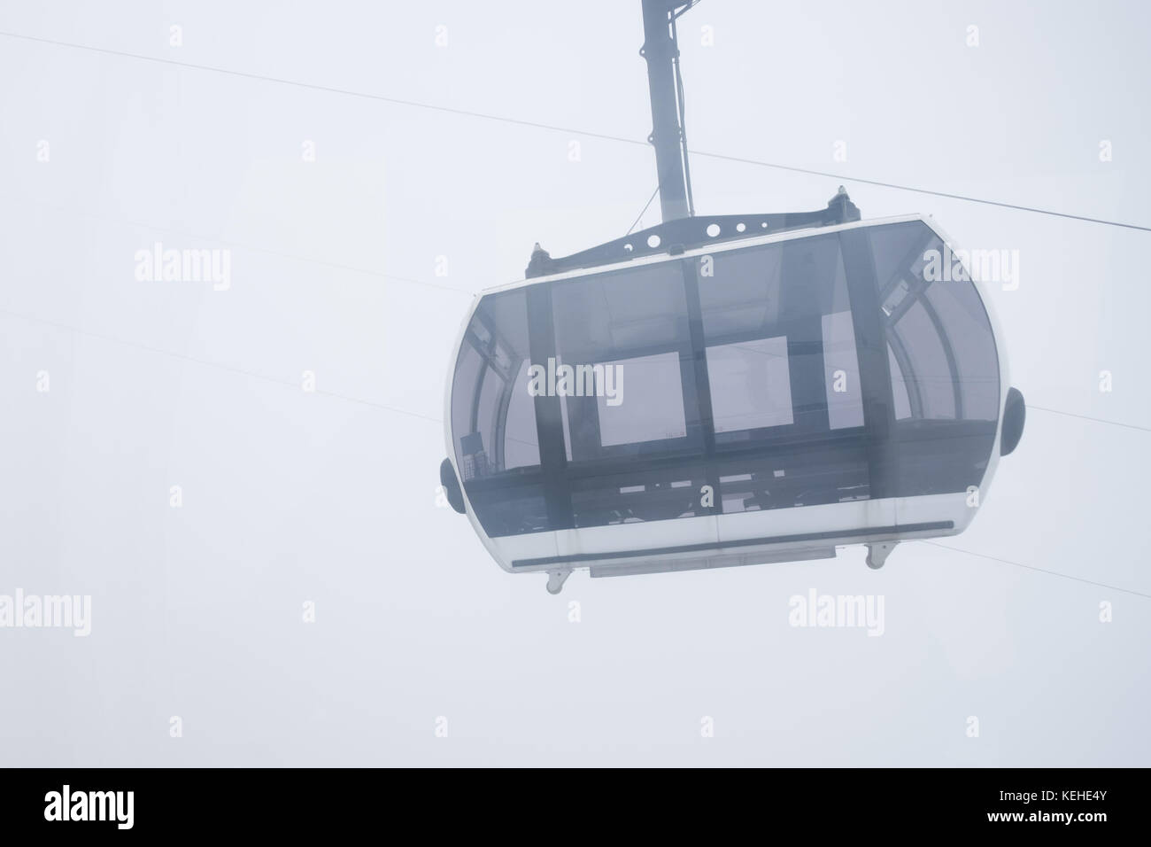 White cable car in fog Stock Photo - Alamy