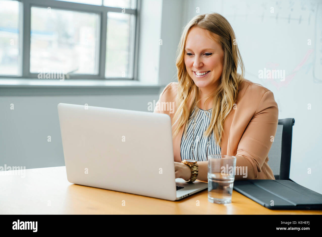 Businesswoman using laptop in conference room Stock Photo - Alamy