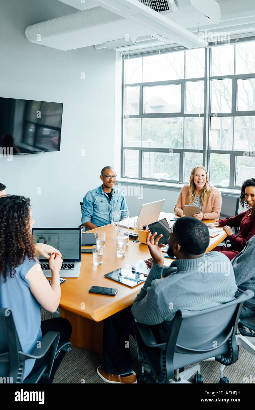 Business people smiling in meeting Stock Photo - Alamy