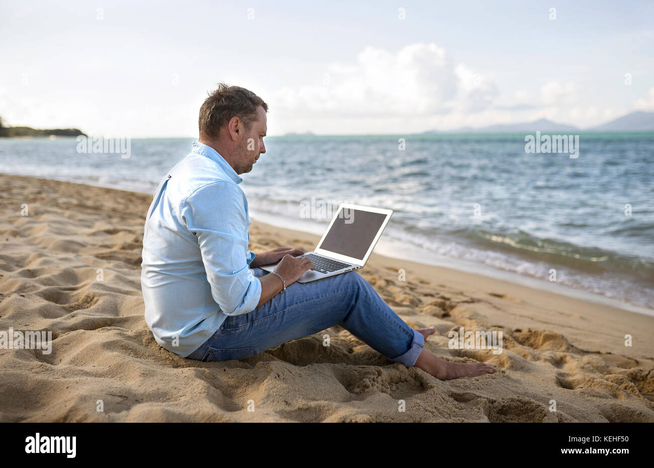 Tropical beach scene laptop hi-res stock photography and images - Alamy