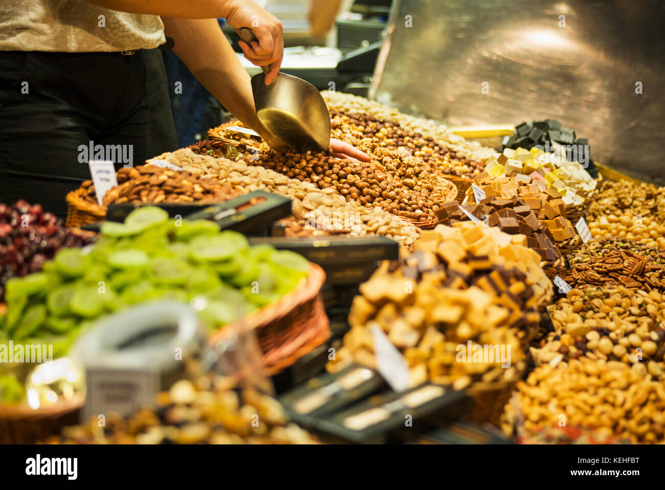 Person scooping nuts at market Stock Photo - Alamy