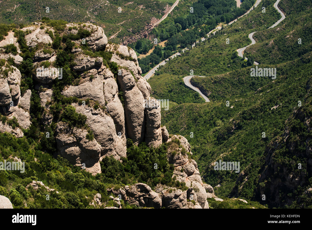 Rock formations overlooking winding road Stock Photo - Alamy