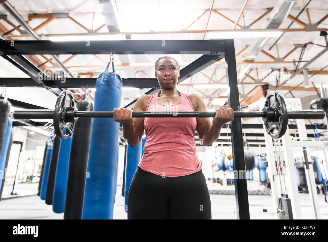 Black woman lifting barbell in gymnasium Stock Photo - Alamy