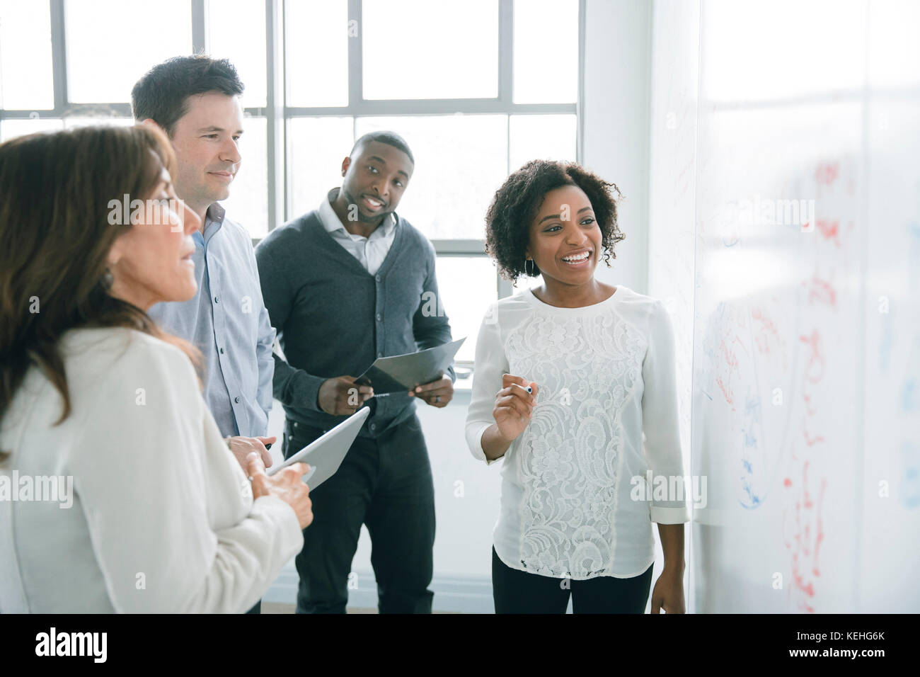 Business people reading whiteboard in meeting Stock Photo - Alamy