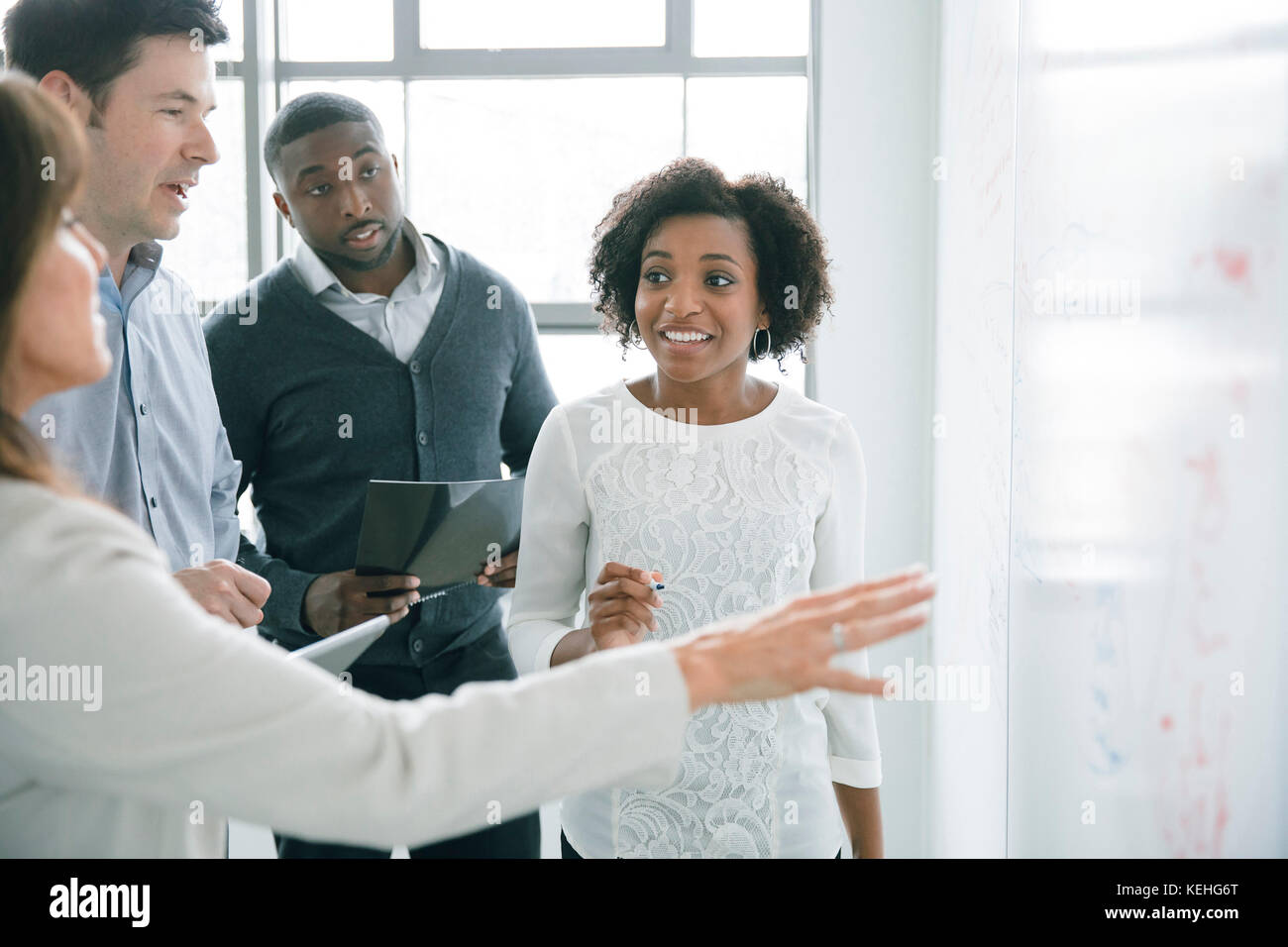Business people talking near whiteboard in meeting Stock Photo - Alamy