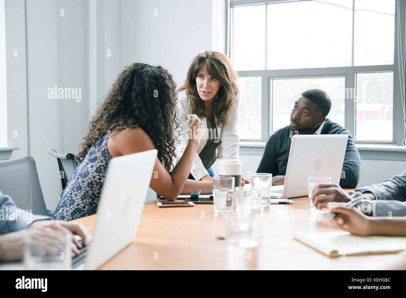 Business people using laptop in meeting Stock Photo - Alamy