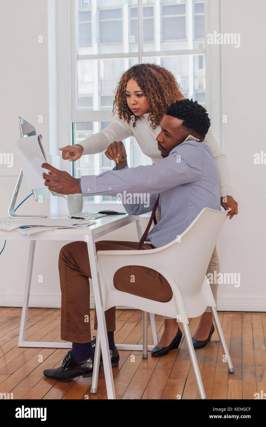Business people talking on cell phone and reading notepad Stock Photo ...